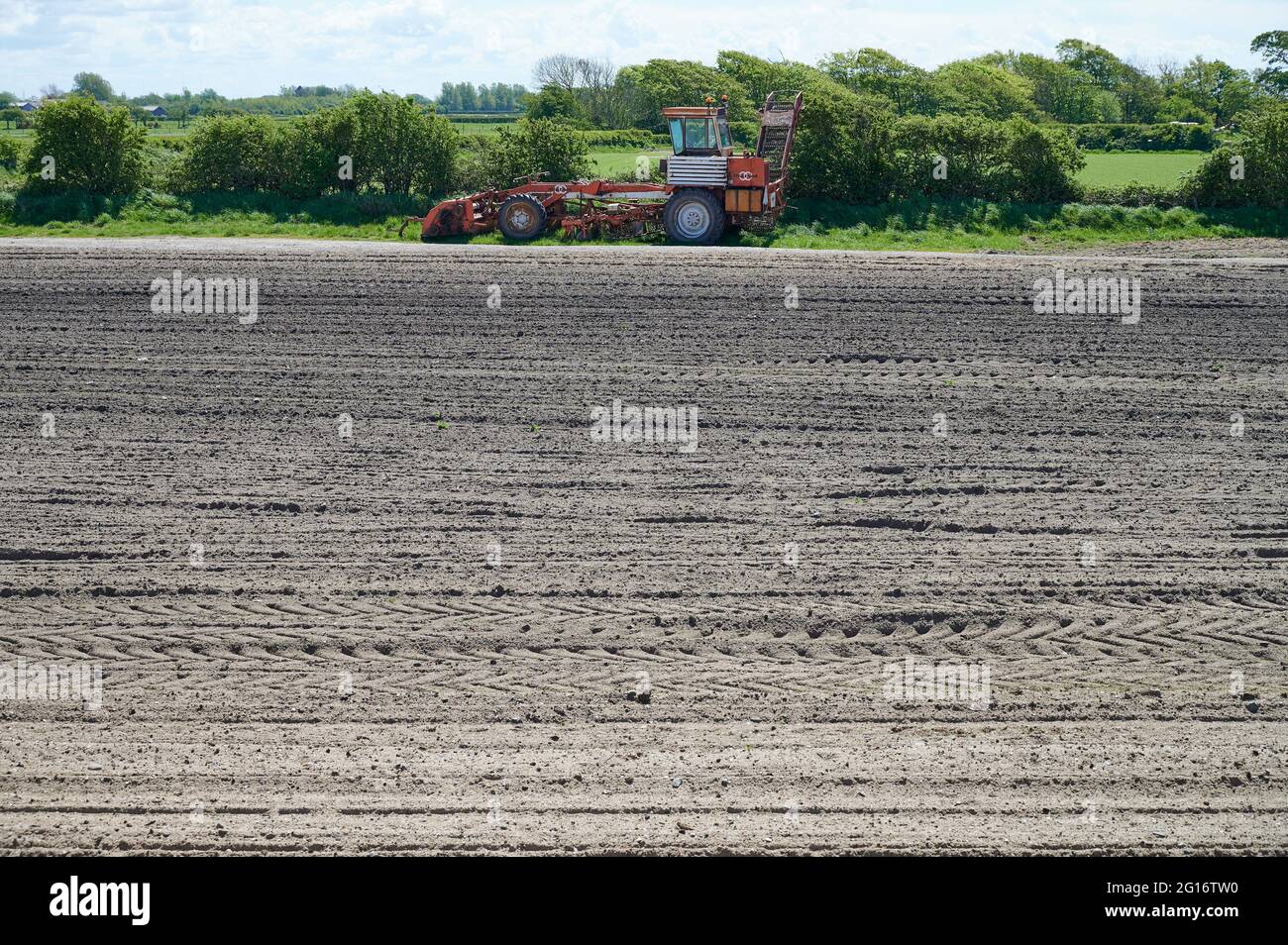 Farm machinary at rear of ploughed field in springtime Stock Photo - Alamy
