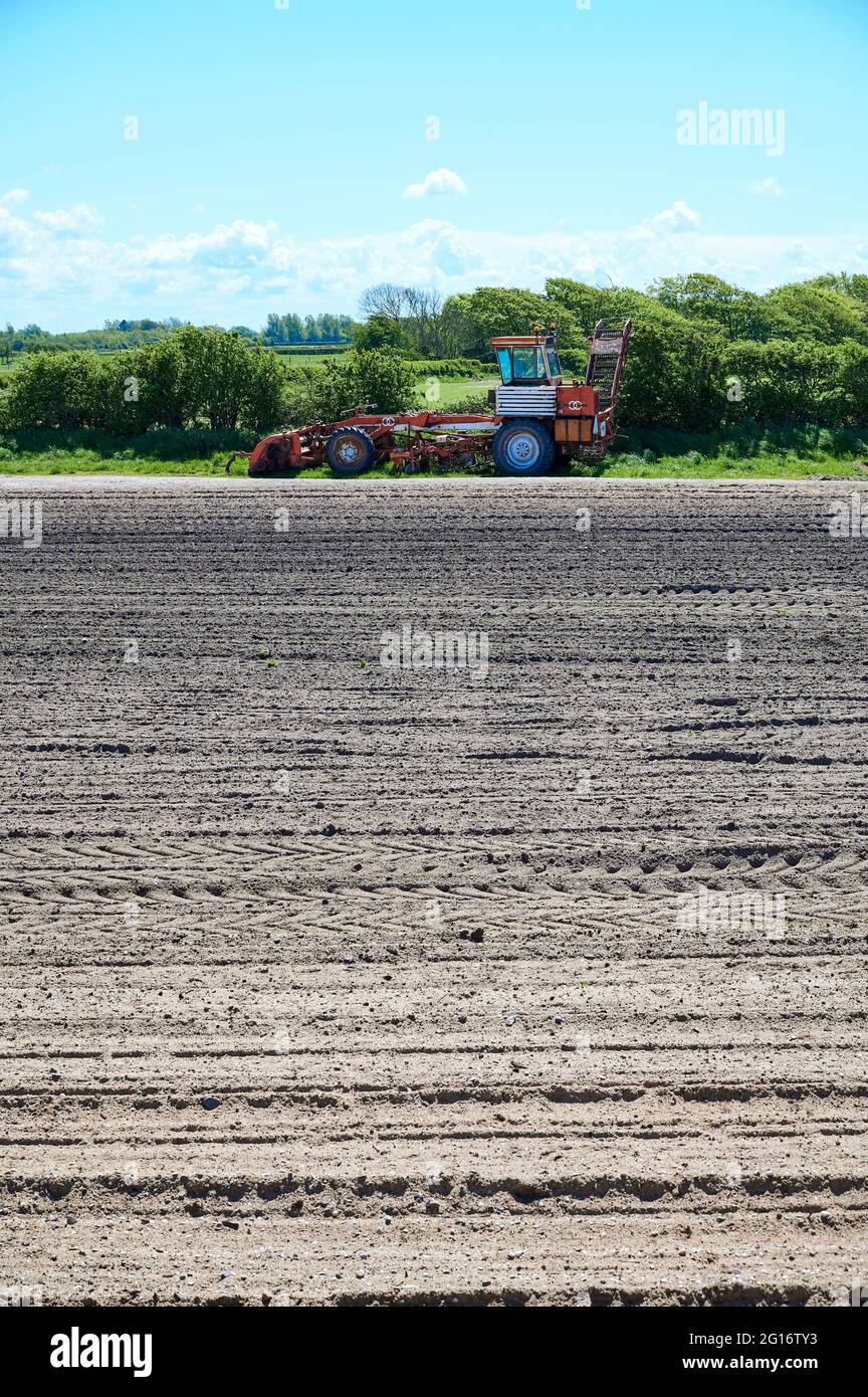 Farm machinary at rear of ploughed field in springtime Stock Photo - Alamy