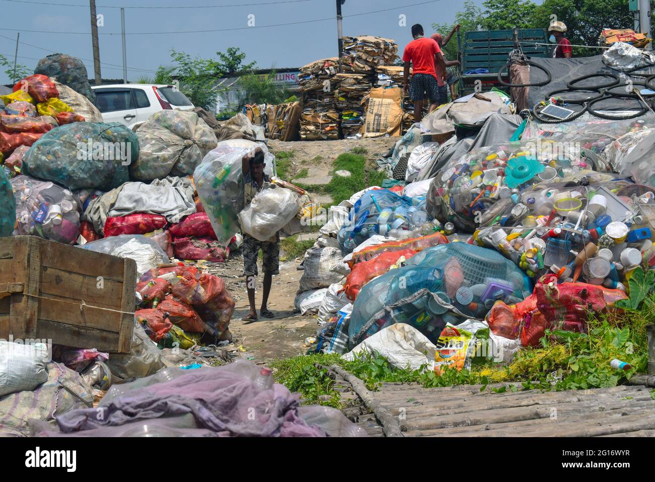 People are working in a garbage yard on World Environment day in ...