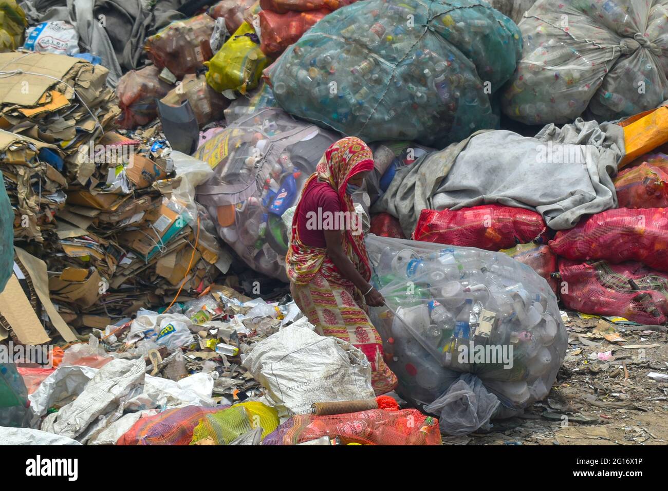 A woman working in a garbage yard on World Environment day in Kolkata ...