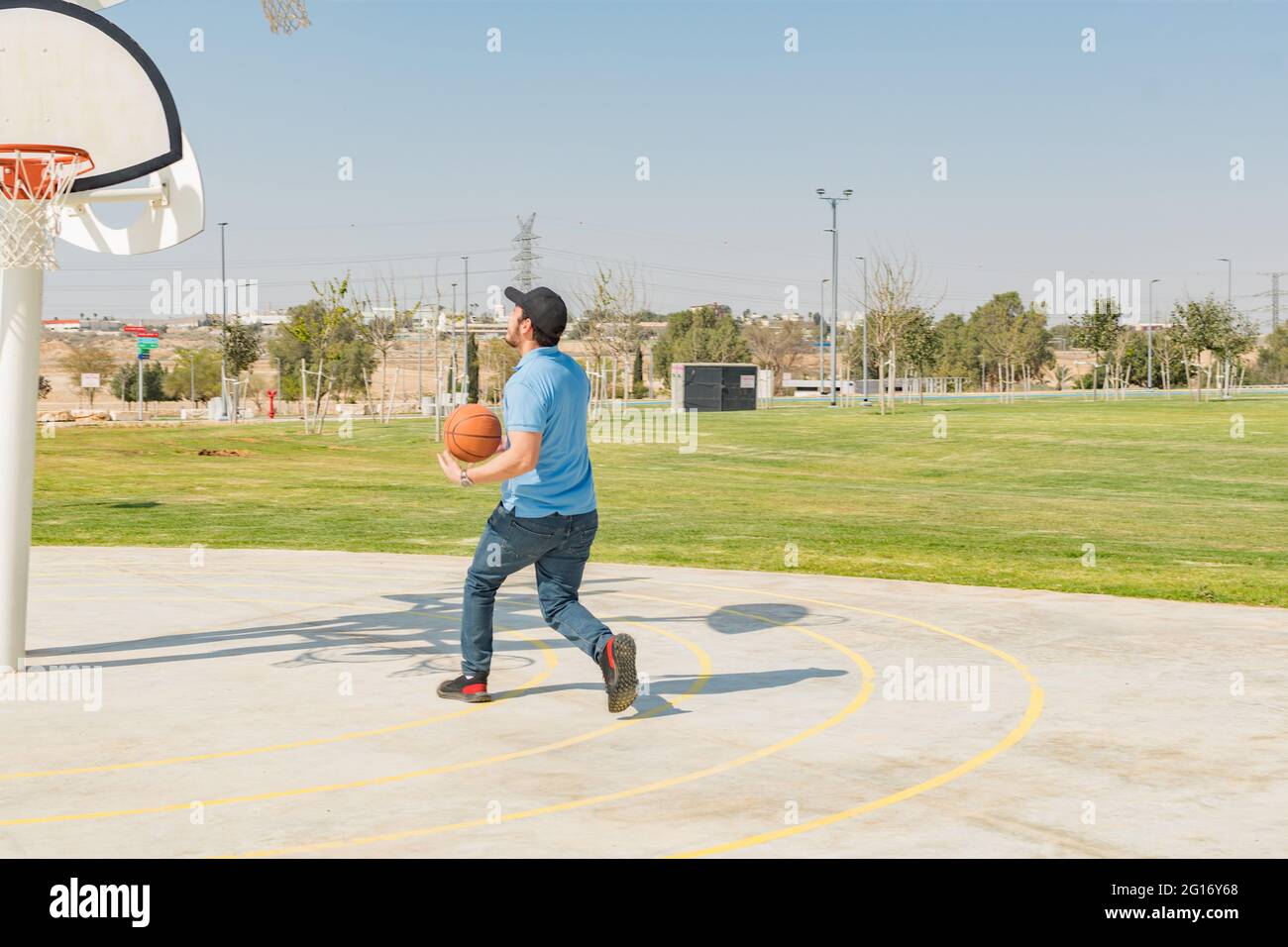 Back view of a young man playing basketball in the sports park Stock ...