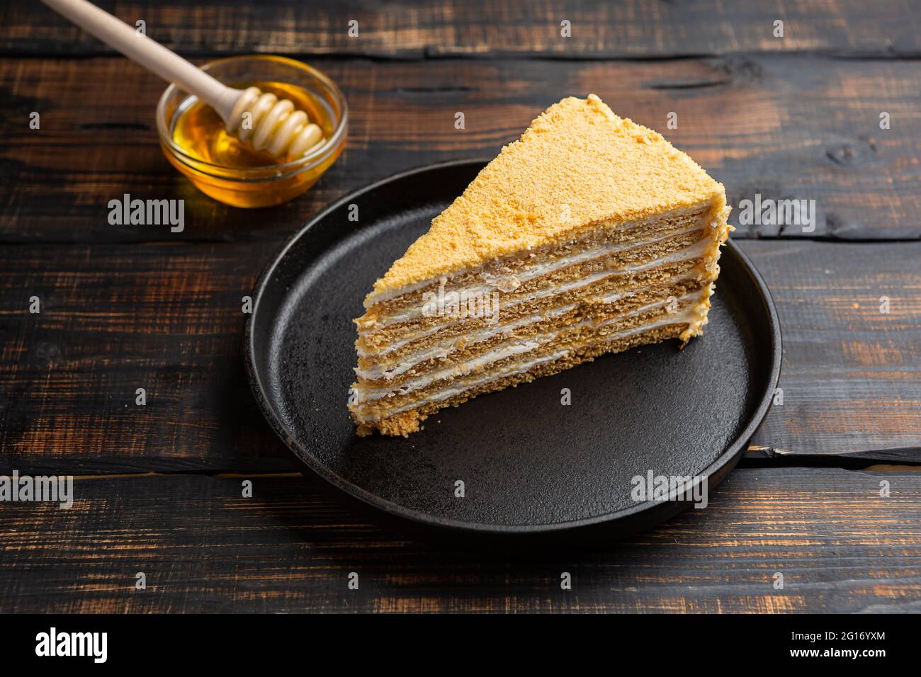 Russian honey layer cake Medovik slice on black plate Stock Photo - Alamy