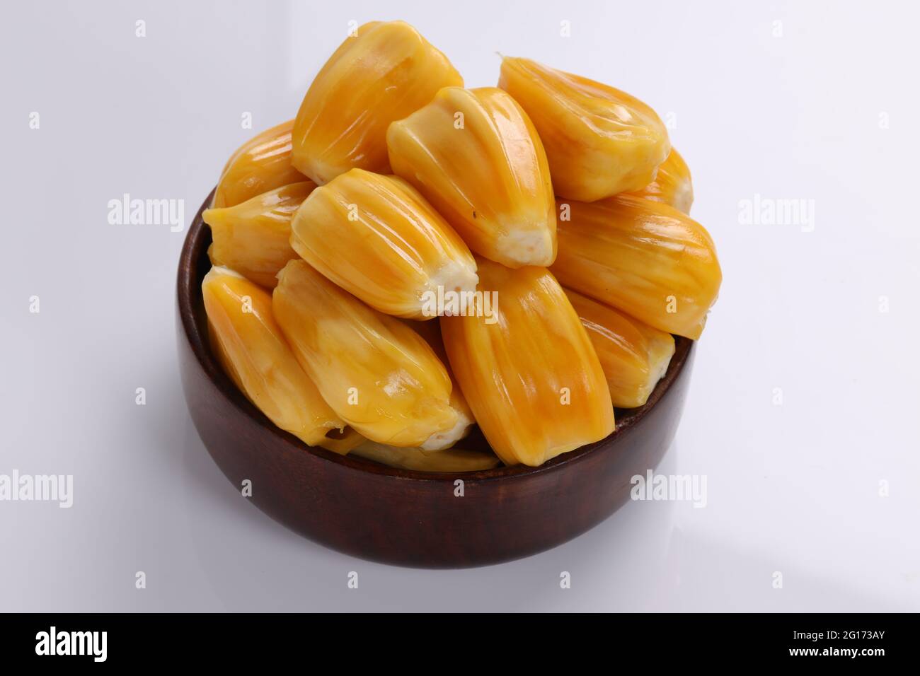 Ripe Jackfruit arranged beautifully in a wooden bowl with white ...