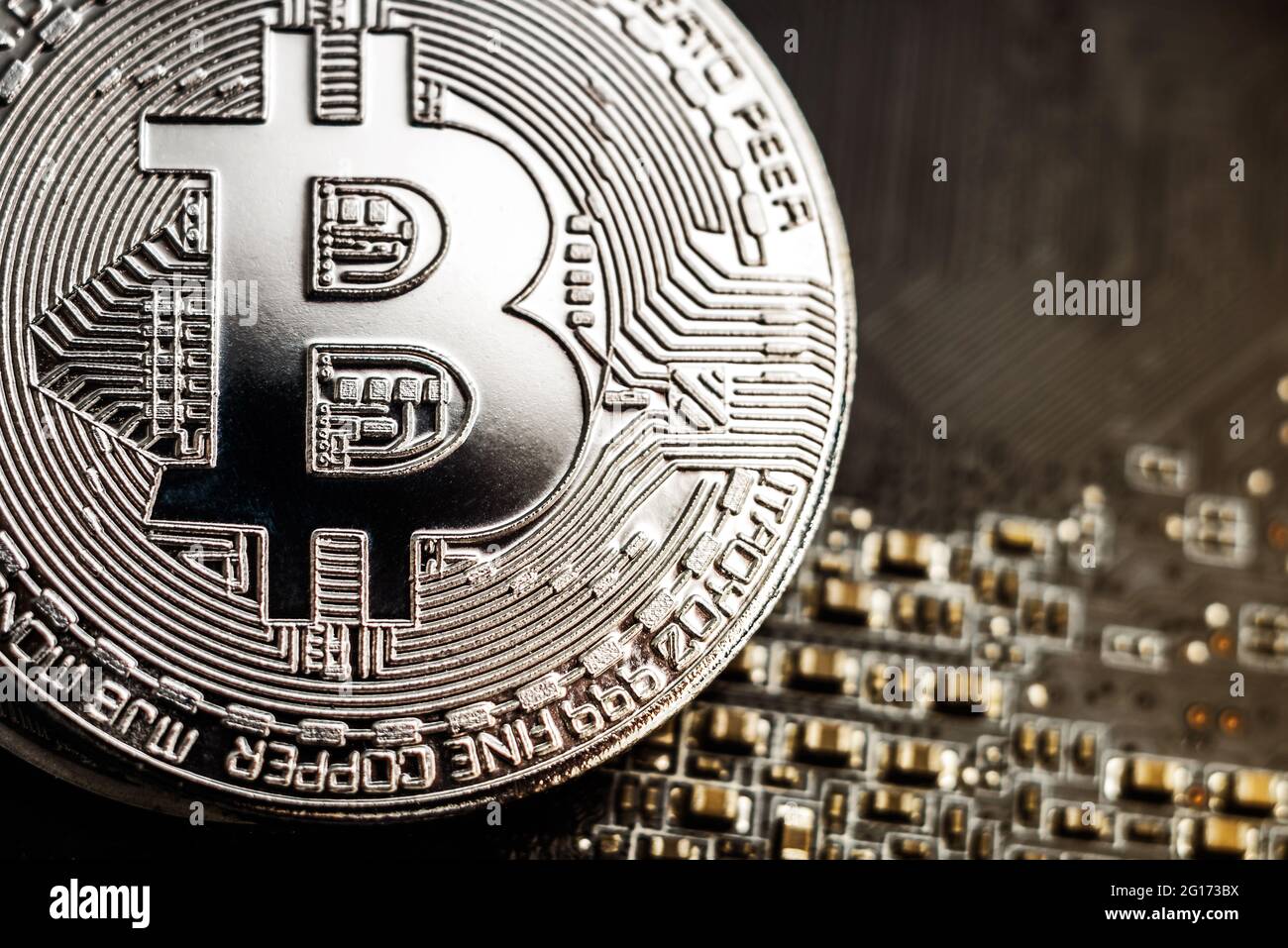 Silver bitcoin on the computer motherboard background Stock Photo - Alamy