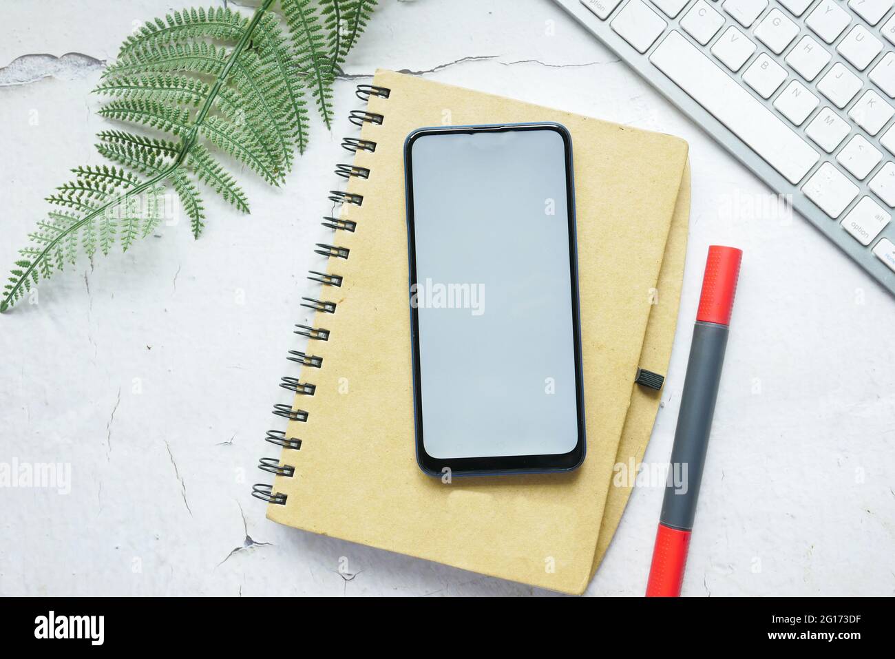 smart phone with empty screen on notepad on table Stock Photo - Alamy