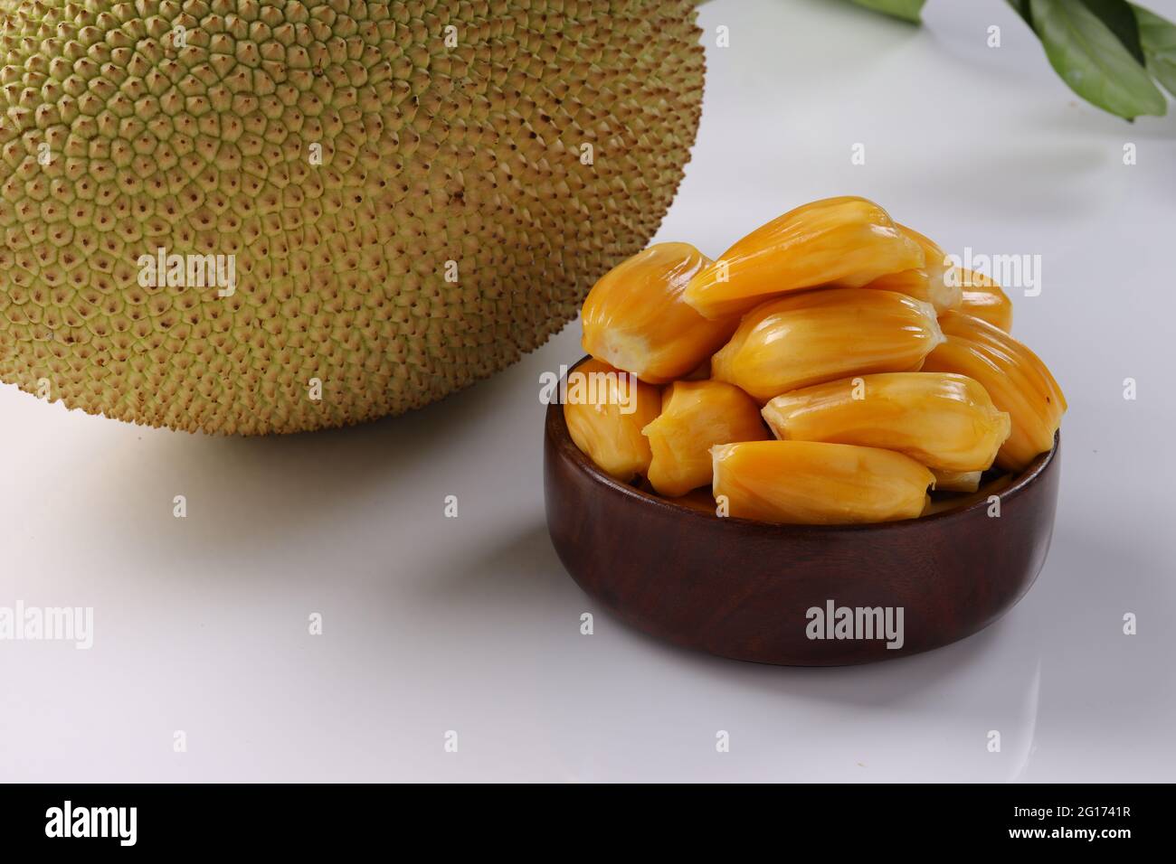 Ripe Jackfruit arranged beautifully in a wooden bowl with white ...