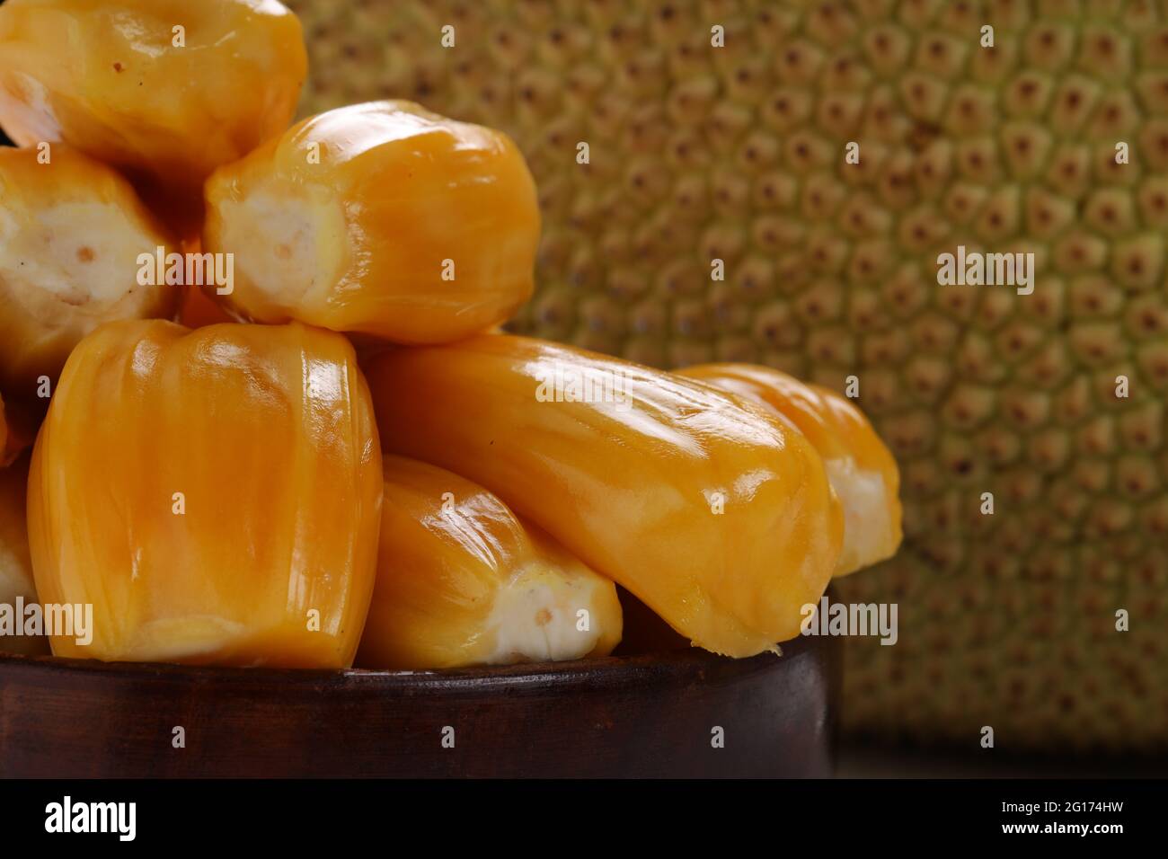 Ripe Jackfruit arranged beautifully in a wooden bowl with white ...
