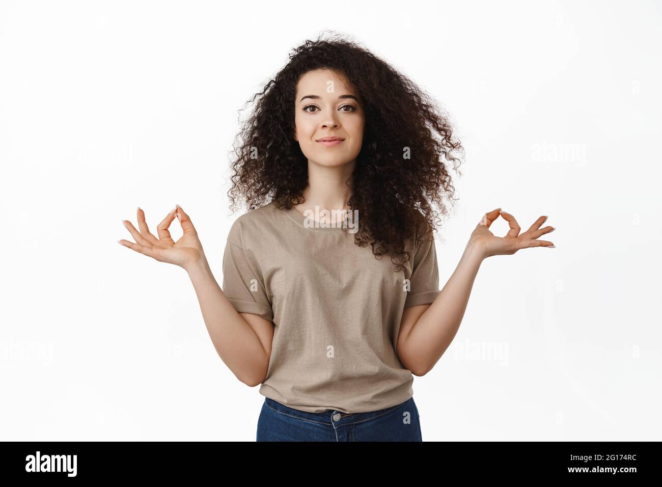 All is zen. Smiling relaxed brunette girl meditating, emotions under ...