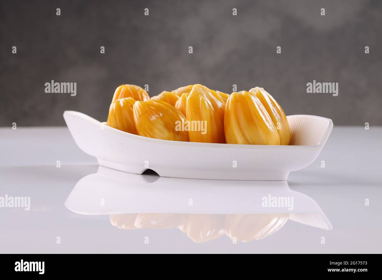 Ripe Jackfruit arranged beautifully in a white table ware with white ...