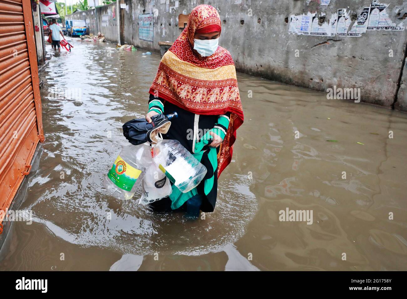 Dhaka, Bangladesh - June 05, 2020: People try to walking through a ...