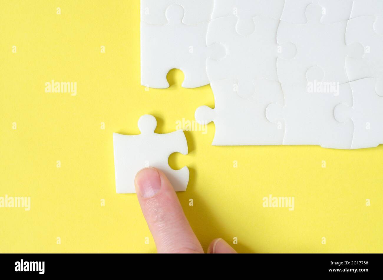 The hand lays down the missing piece of the puzzle. Last piece of ...