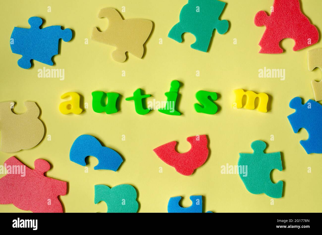 The word autism from colored letters with elements of a multicolored ...