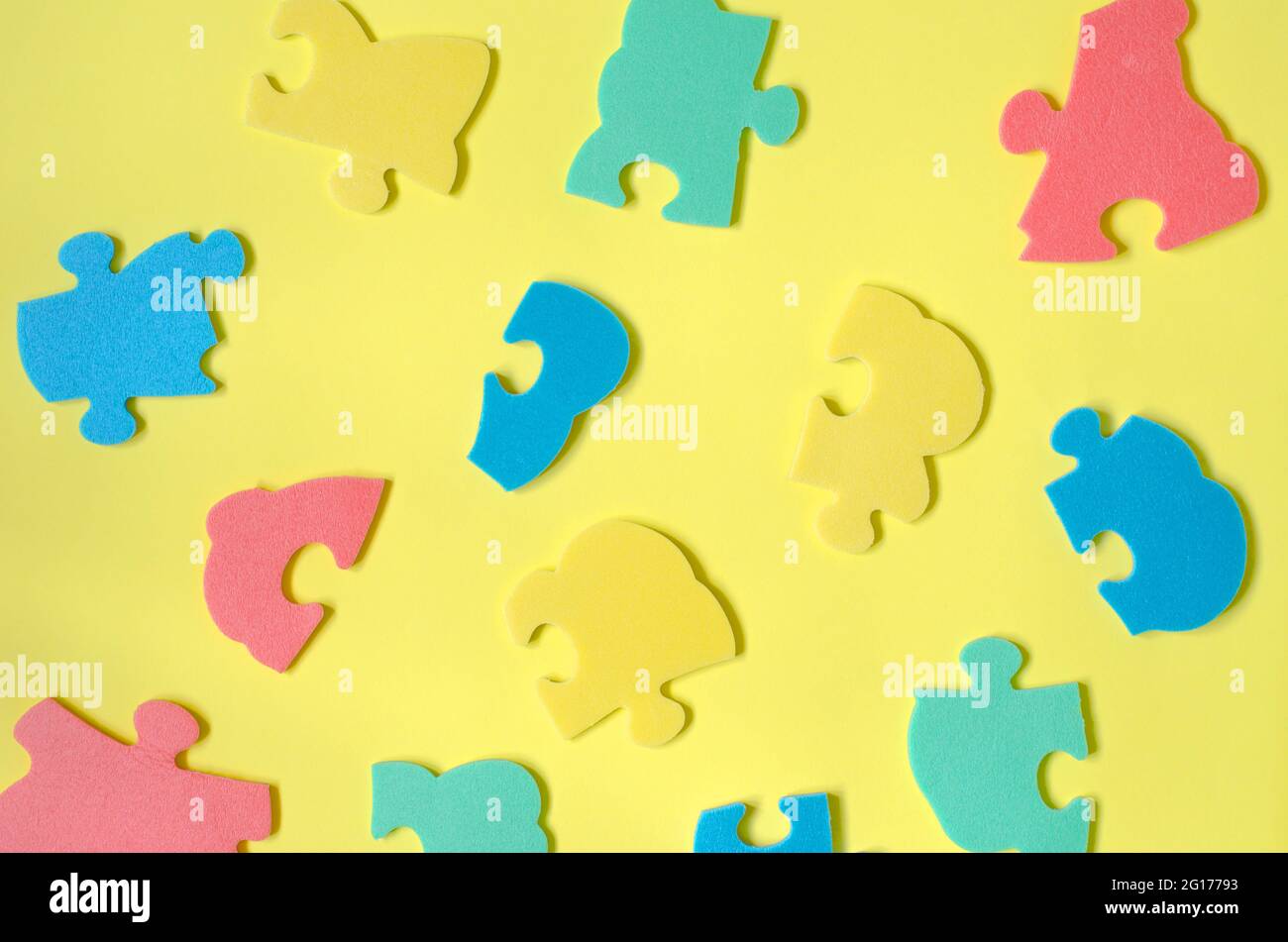 Elements of a multi-colored puzzle on a yellow background. Child ...
