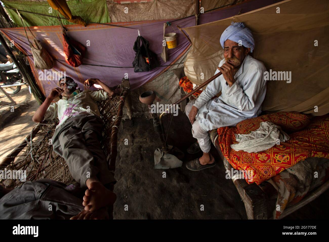 A young man and old man are smoking inside a room Stock Photo - Alamy