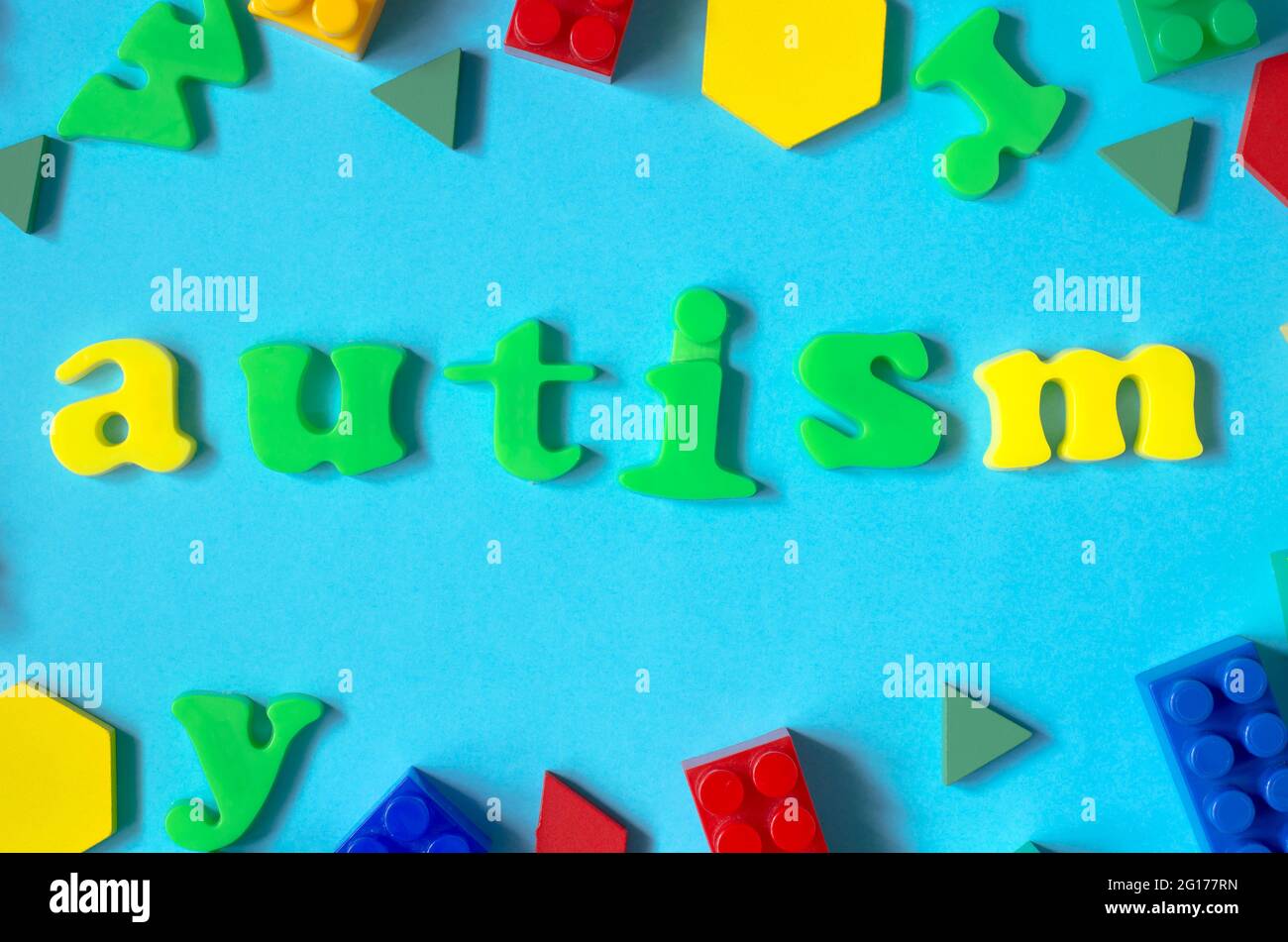 The word autism from colored letters on a blue background with elements ...