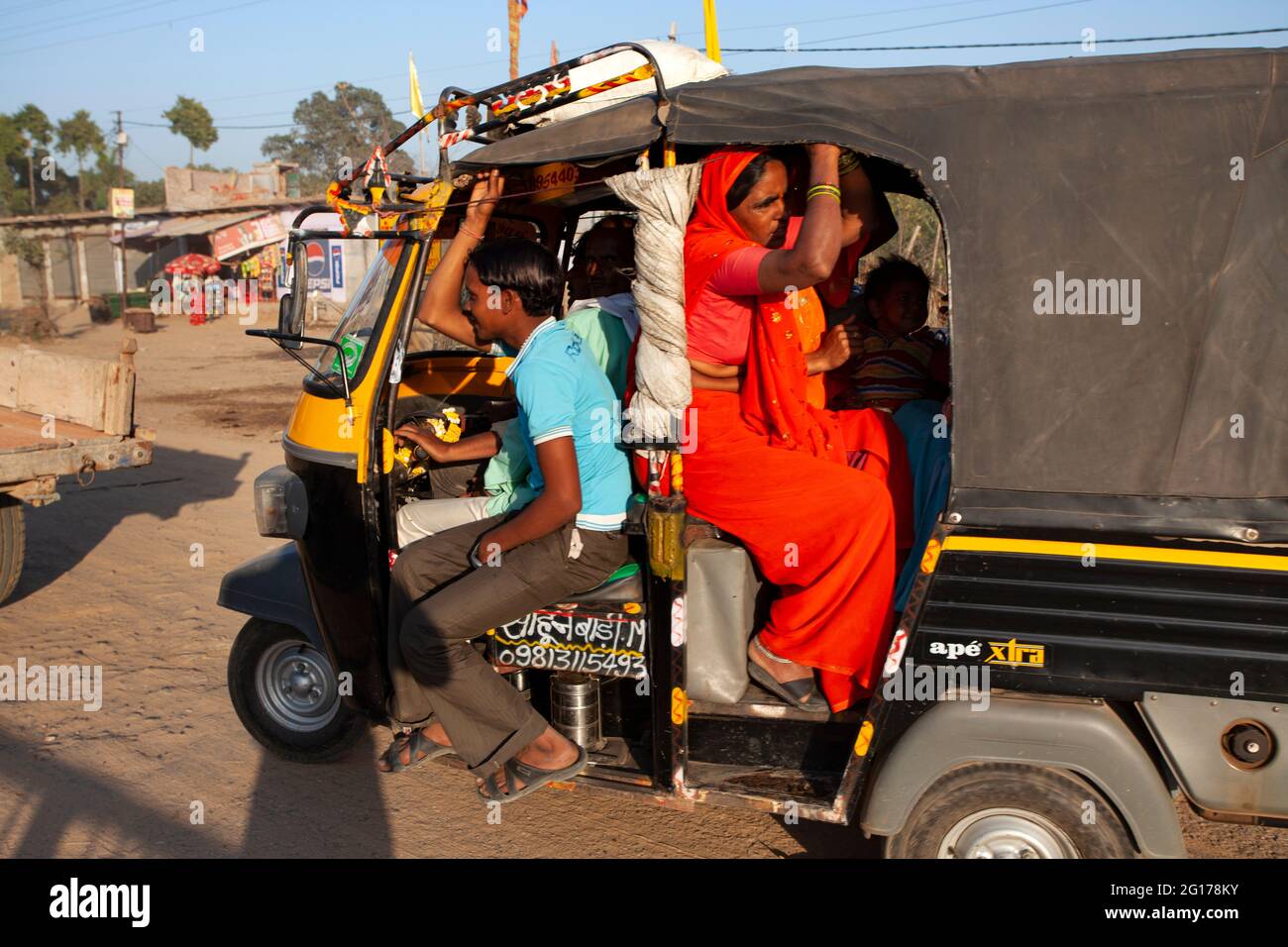 A three wheeler Auto is carrying passengers packed in street Stock ...