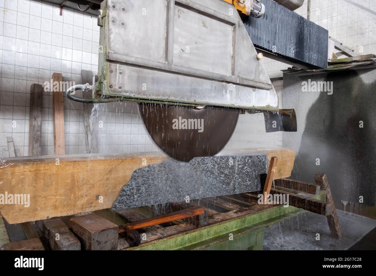 Machine for cutting granite stones. Cutting granite in a stonemason's ...