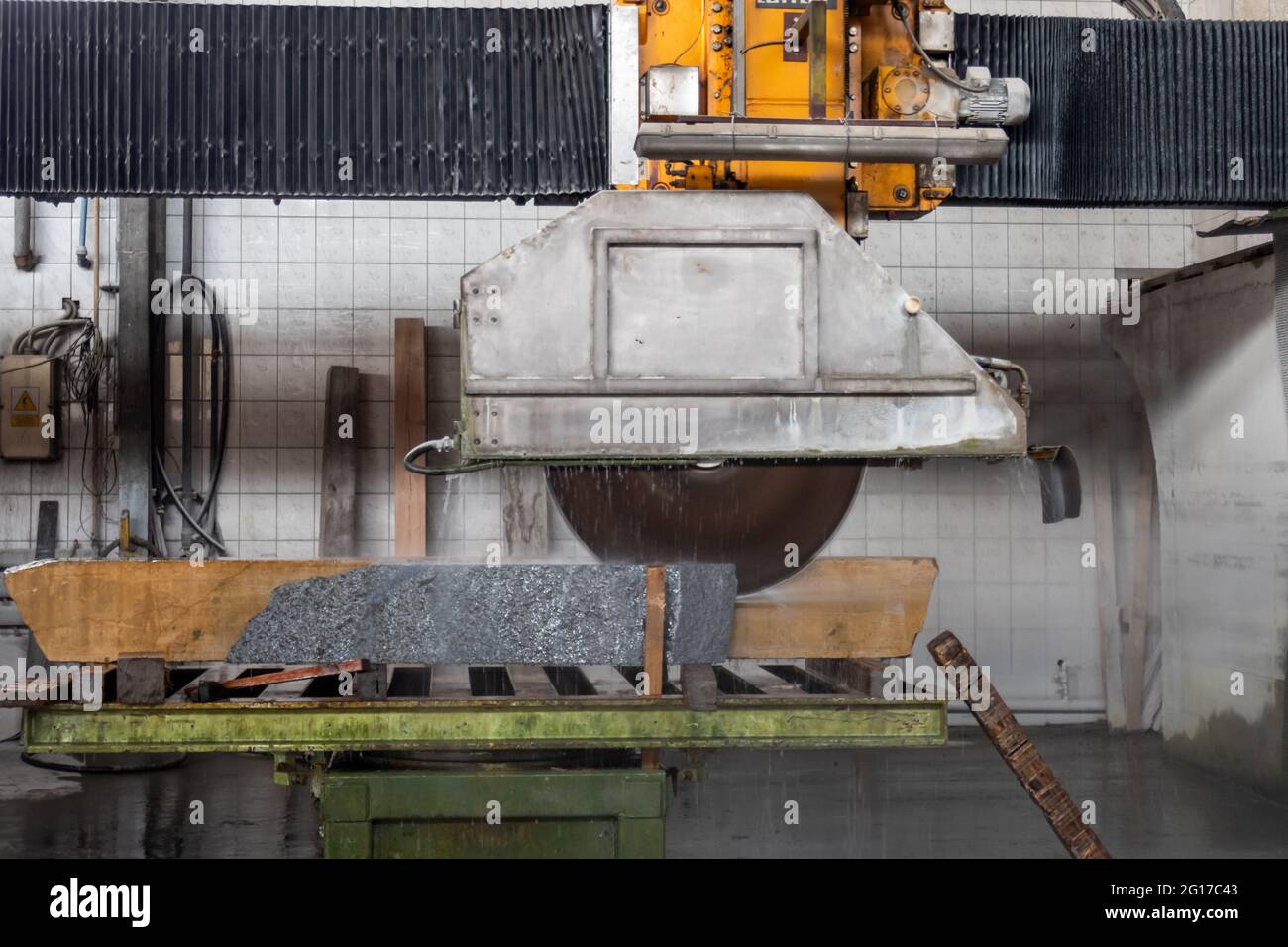 Machine for cutting granite stones. Cutting granite in a stonemason's ...