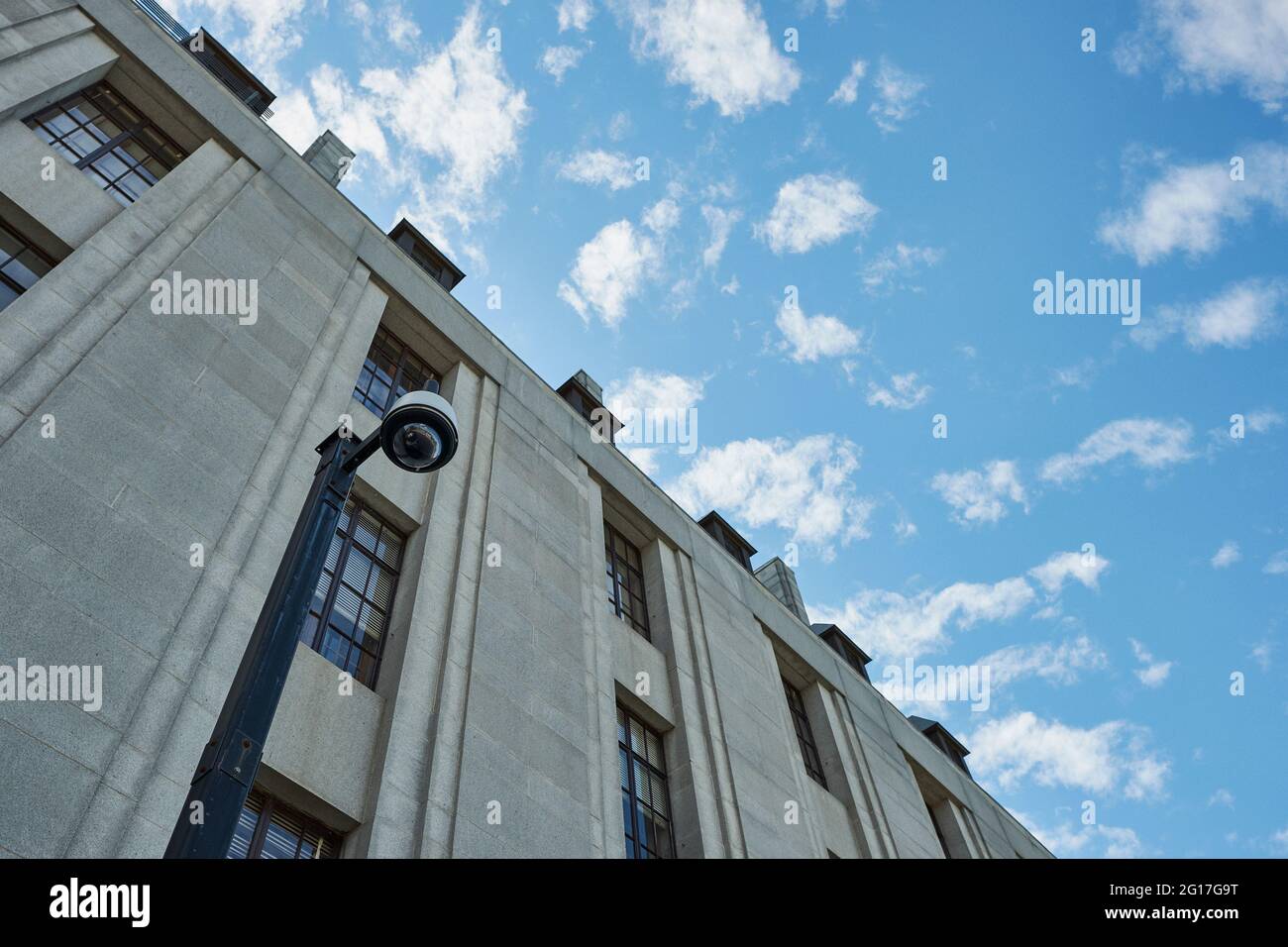 Security camera on the side of building outside Stock Photo - Alamy
