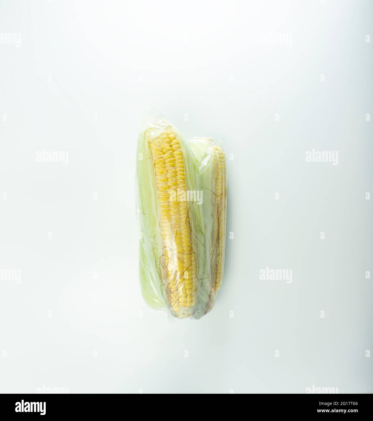 Fresh corn wrapped in a transparent plastic container Stock Photo - Alamy