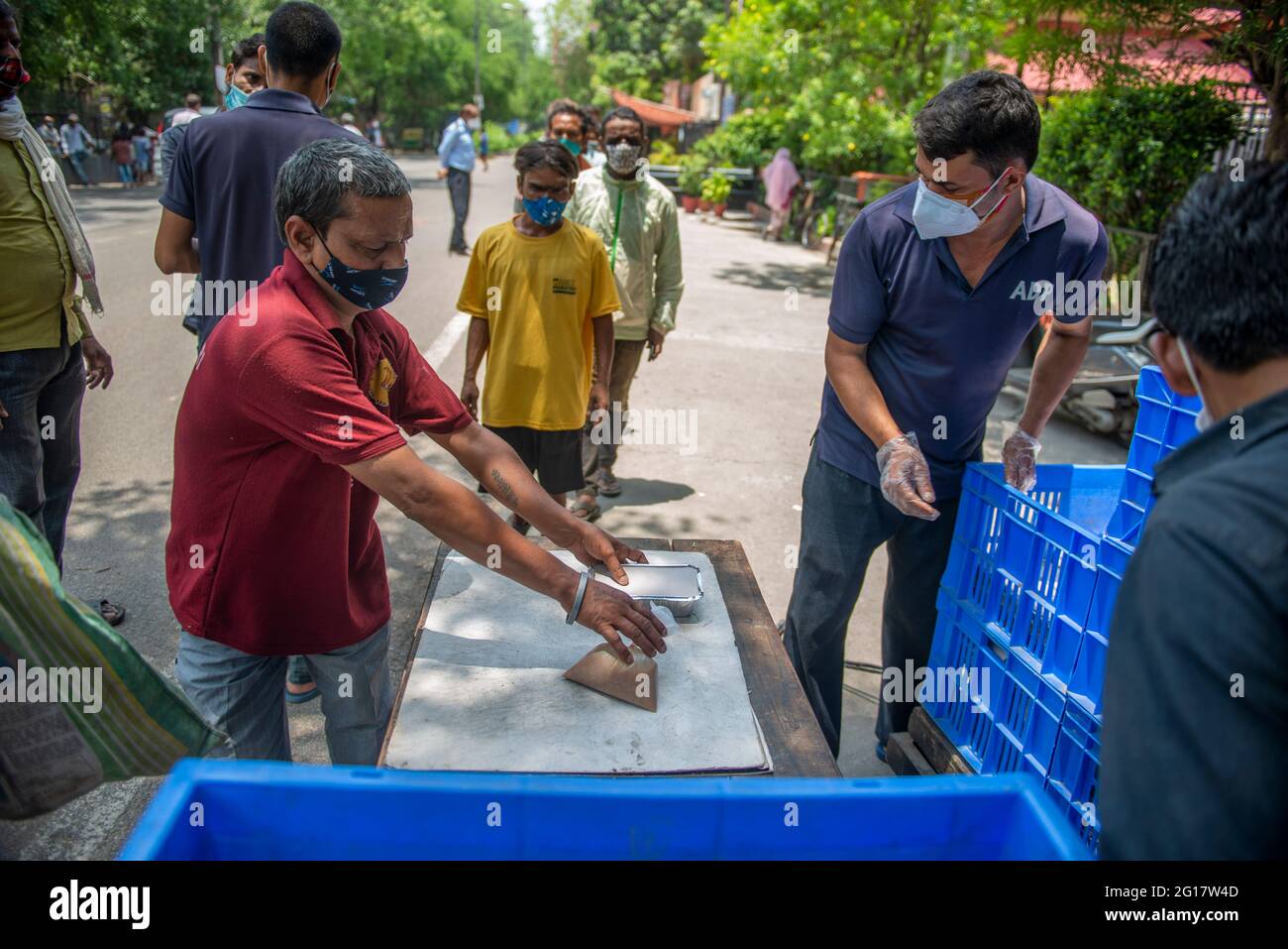 New Delhi, India. 05th June, 2021. Indian man receives food packets ...