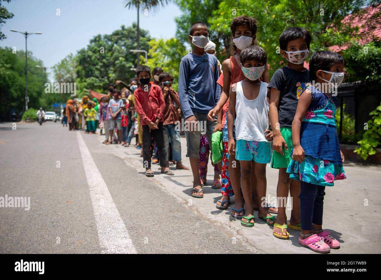 New Delhi, India. 05th June, 2021. Indian children wait in a queue for ...