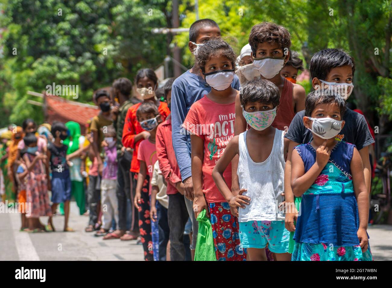 New Delhi, India. 05th June, 2021. Indian children wait in a queue for ...