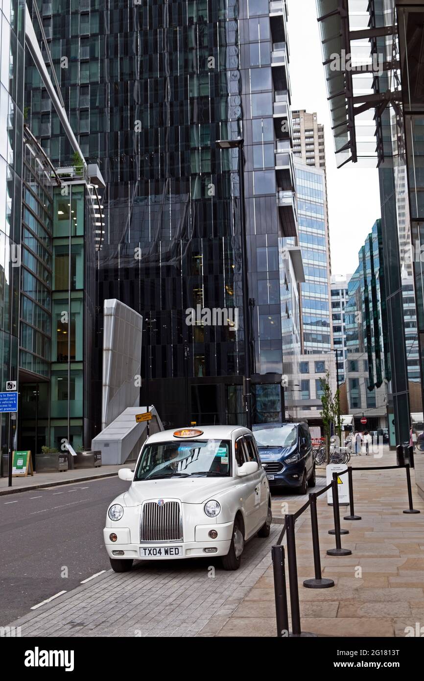 White taxi cab parked in the street outside 25 Ropemaker Place office ...