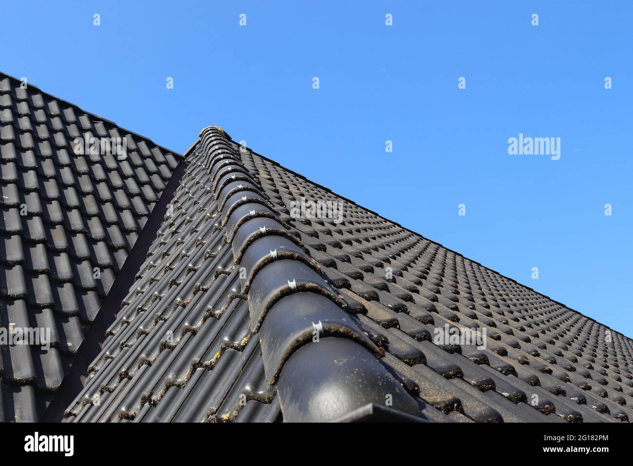Roof window in velux style with black roof tiles Stock Photo - Alamy
