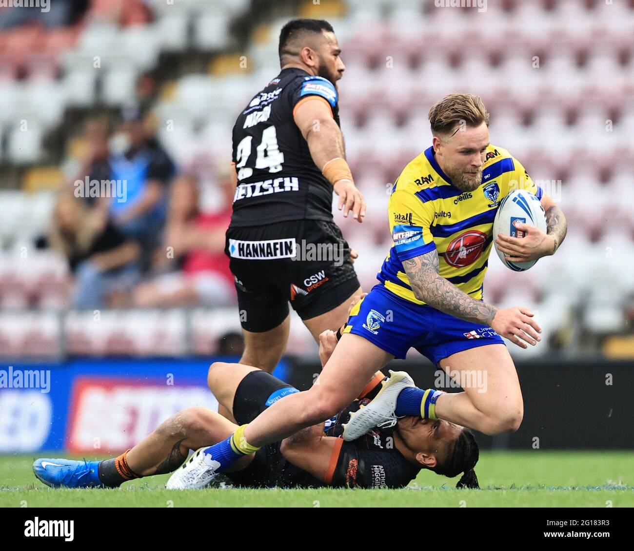 Blake Austin (6) of Warrington Wolves is tackled by Jesse Sene-Lefao ...