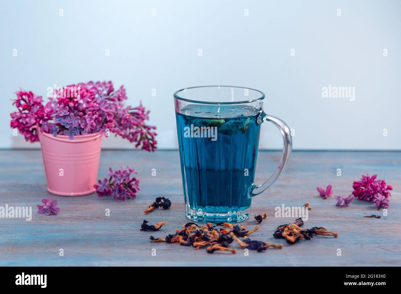 Organic Butterfly pea flowers blue Anchan tea in a glass cupand lilac ...