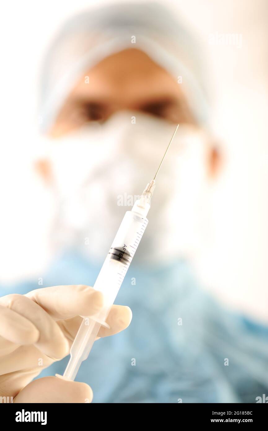 Doctor at hospital holding needle Stock Photo - Alamy