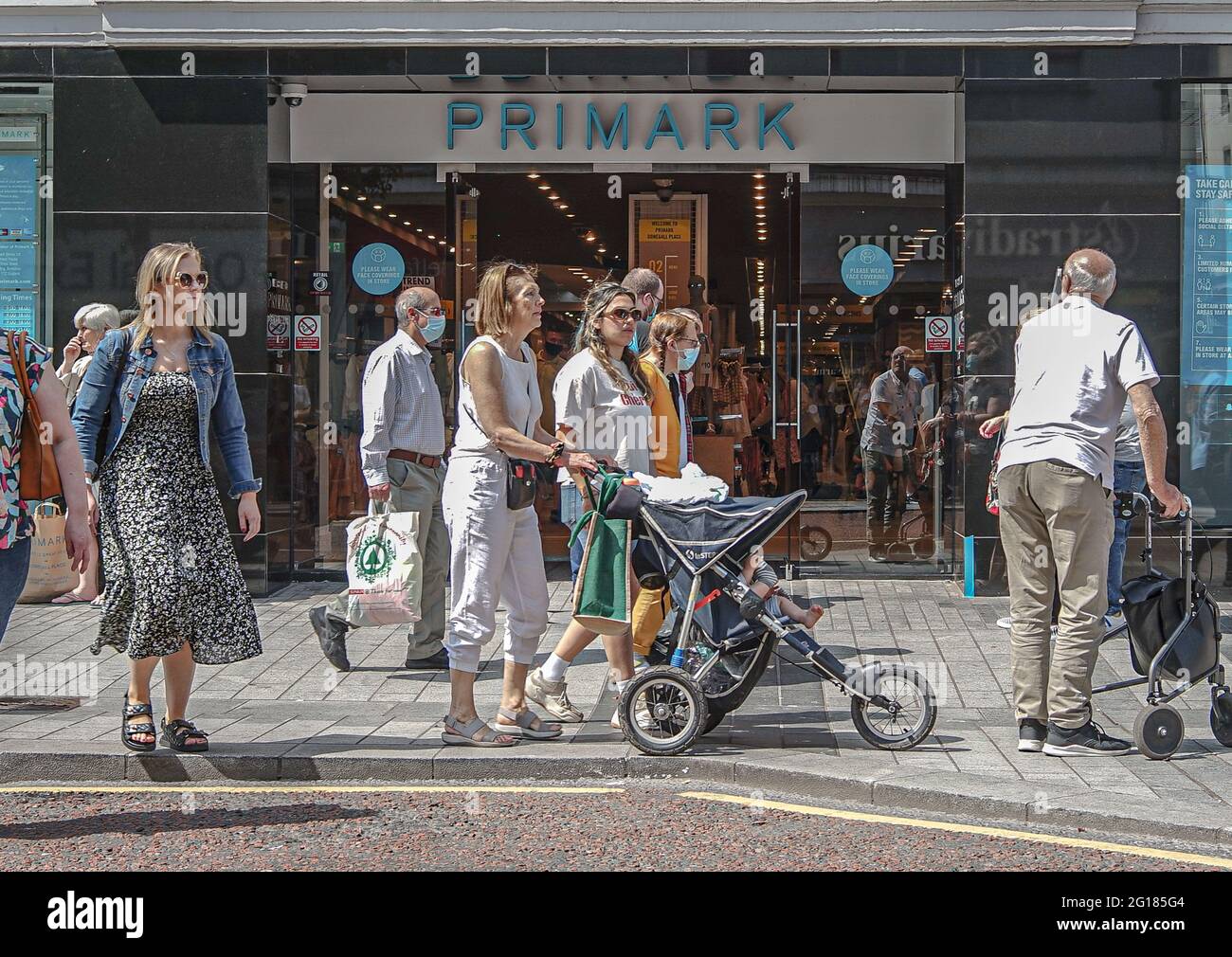 Shoppers wait outside Primark fashion Store on Royal Avenue in Belfast ...