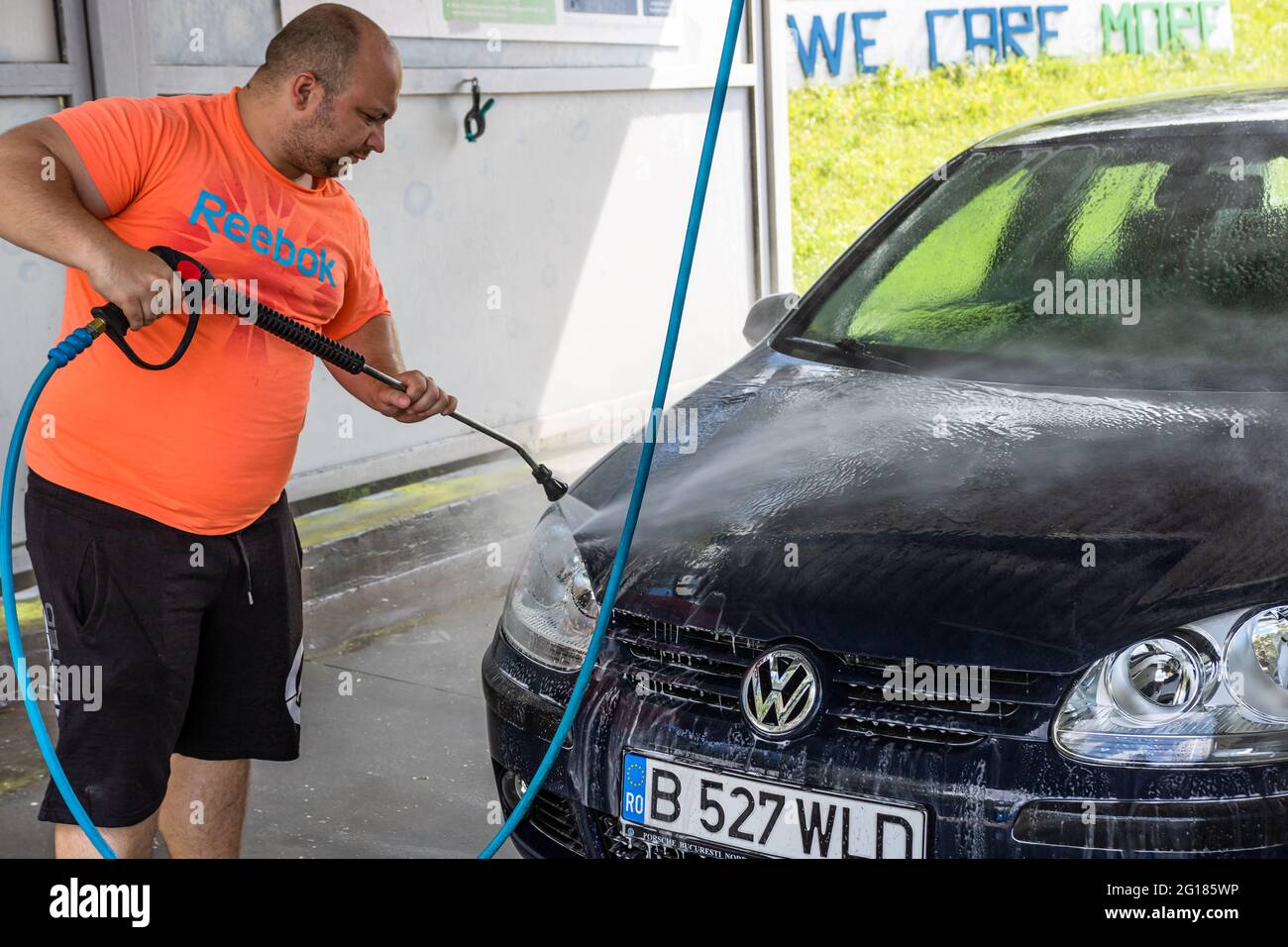 Washing and cleaning car in self service car wash station. Car washing using high pressure water ...