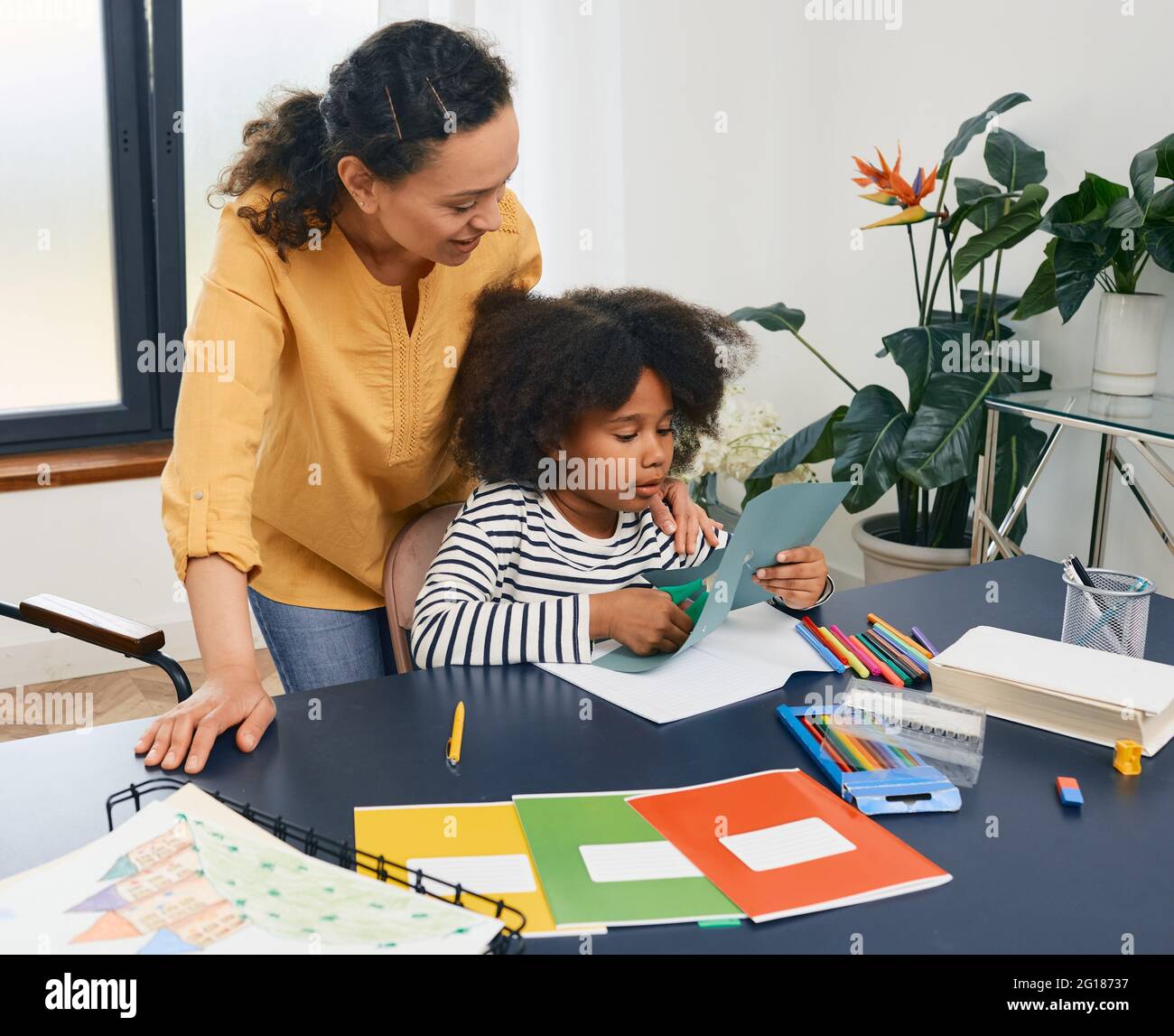 Art psychotherapy for kids. Child psychologist works with African ...