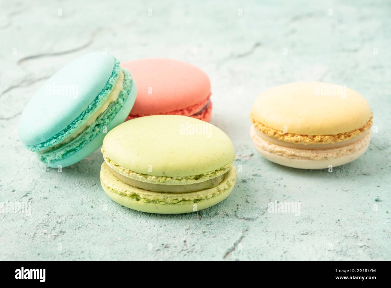 closeup colorful macaroons on green background with copy space Stock ...