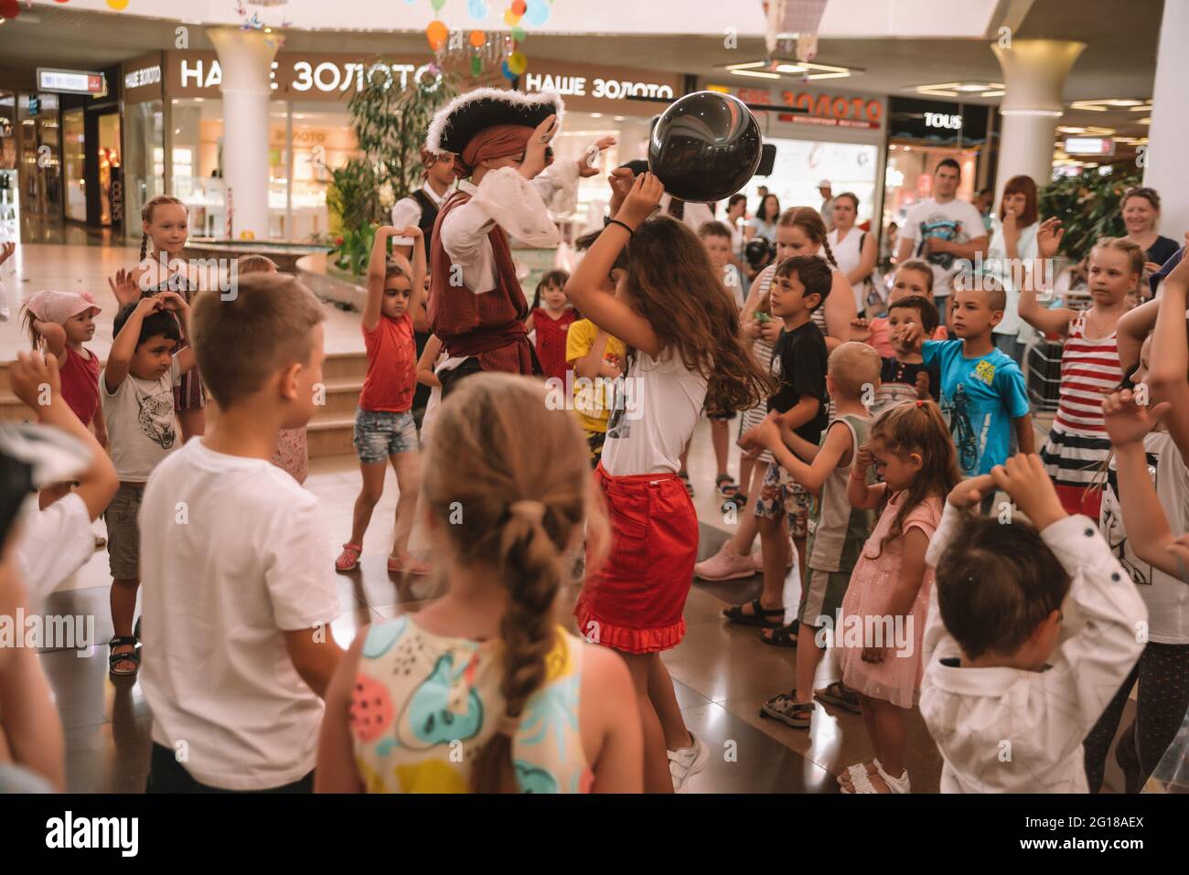 Happy kids celebrating party in the mall, in a shopping center ...