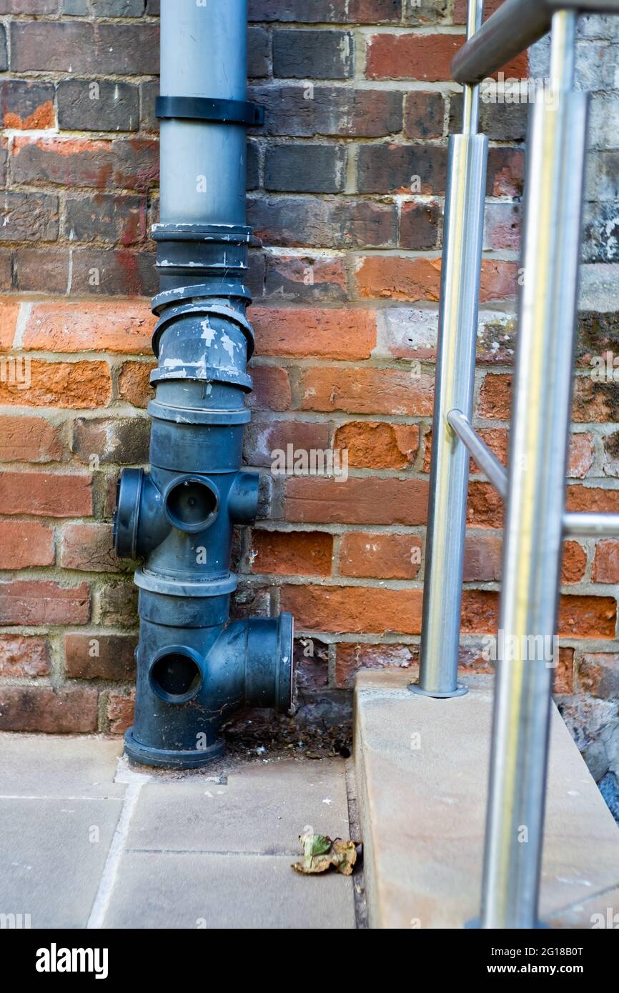 Close and selective focus on black drain pipe and waster water ...