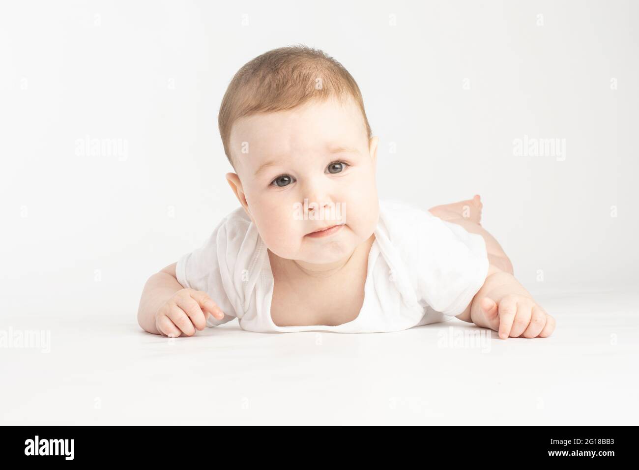 portrait of a baby, face without emotions, look at the camera on a ...