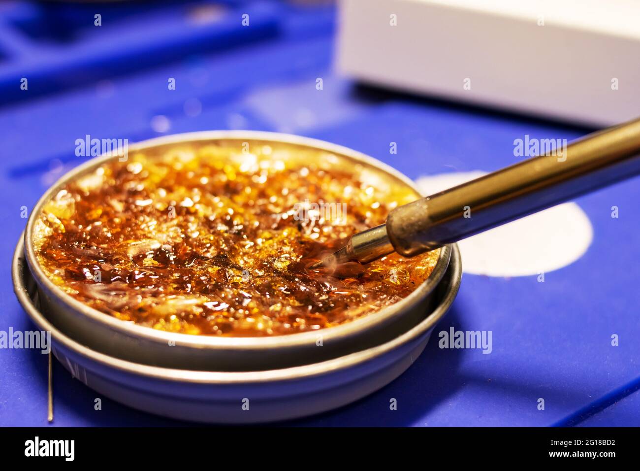 Hot soldering iron and yellow rosin close up Stock Photo - Alamy