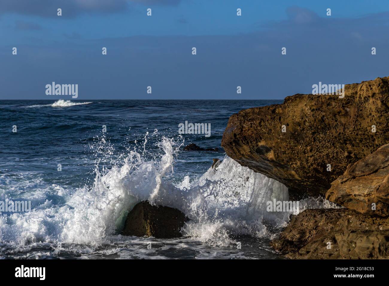 Wave breaking on rock in Laguna Beach, California. Water spilling ...