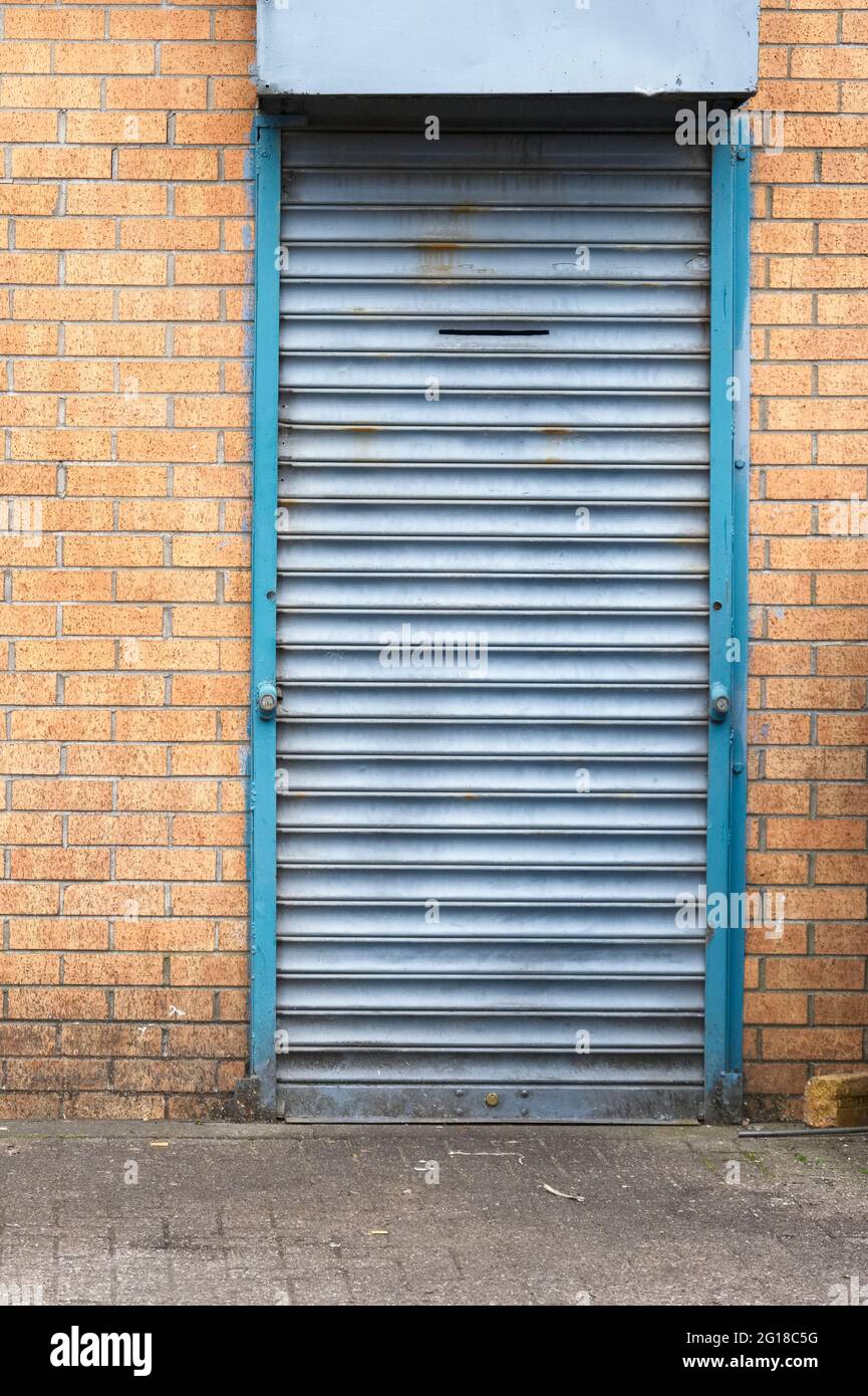 Shop front with blank sign and closed shutter door Stock Photo - Alamy
