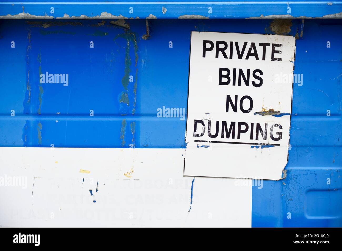 Private bins no dumping sign on blue skip Stock Photo - Alamy