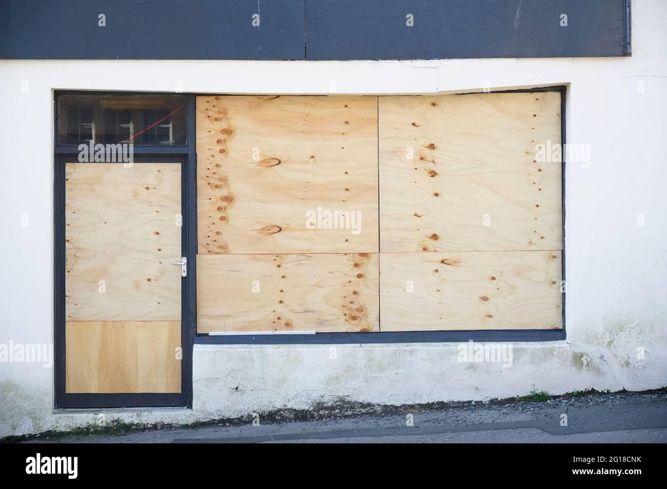 Shop front with blank sign and closed shutter door Stock Photo - Alamy