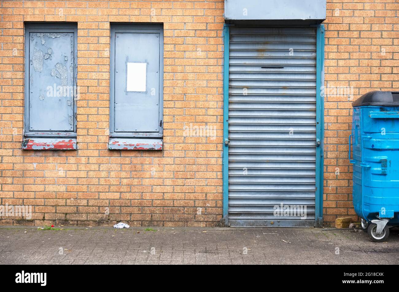 Shop front with blank sign and closed shutter door Stock Photo - Alamy