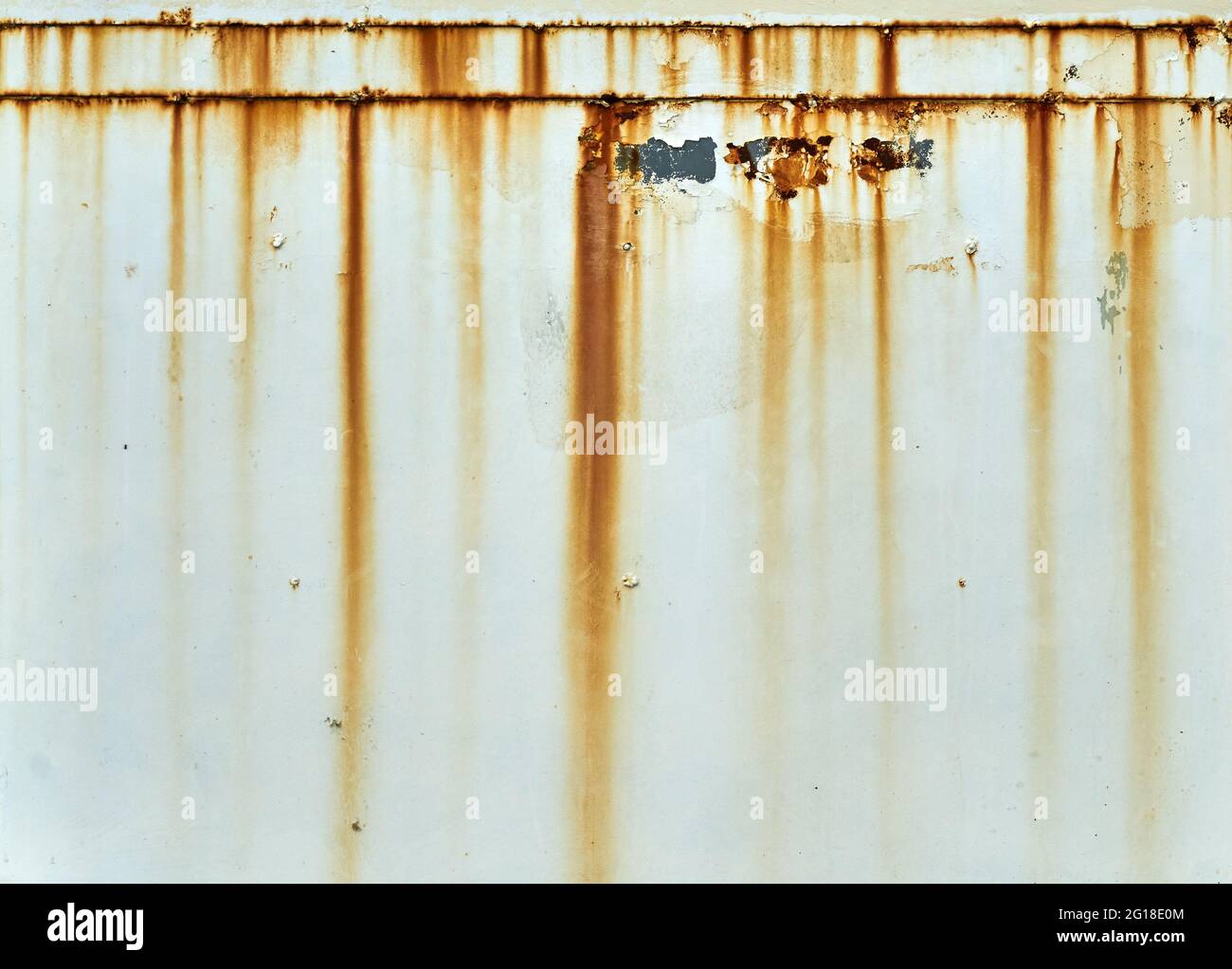Orange rust streaks down a white wall Stock Photo - Alamy