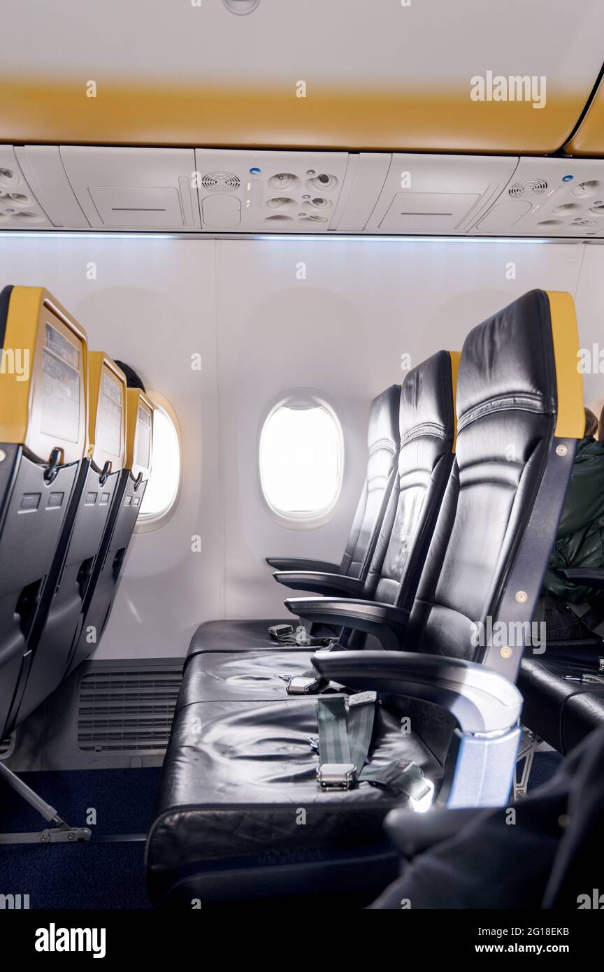 Empty passenger plane cabin. A row of chairs. Nobody Stock Photo - Alamy