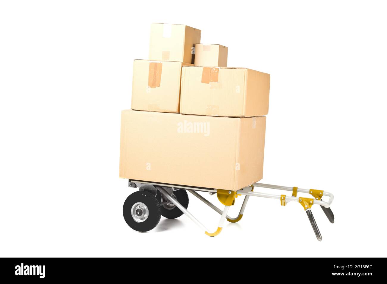 Heap or stack of brown carton transport boxes with barrow over white ...