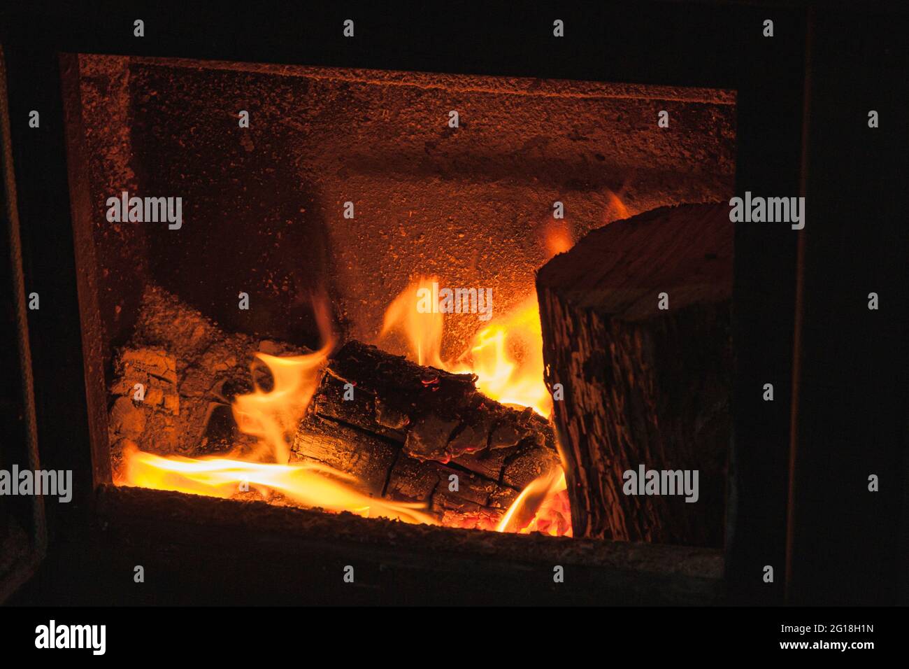 Firewood burning inside of a stove Stock Photo - Alamy