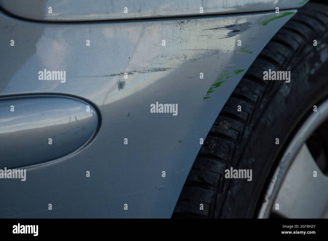 Scratches and bumps on the body of a light blue car Stock Photo - Alamy
